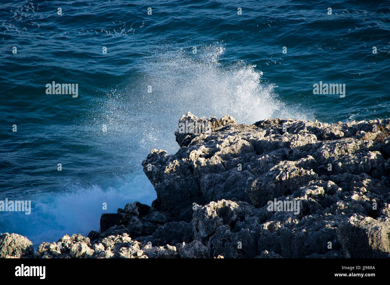 Coastal Scene - waves against rocks Stock Photo - Alamy