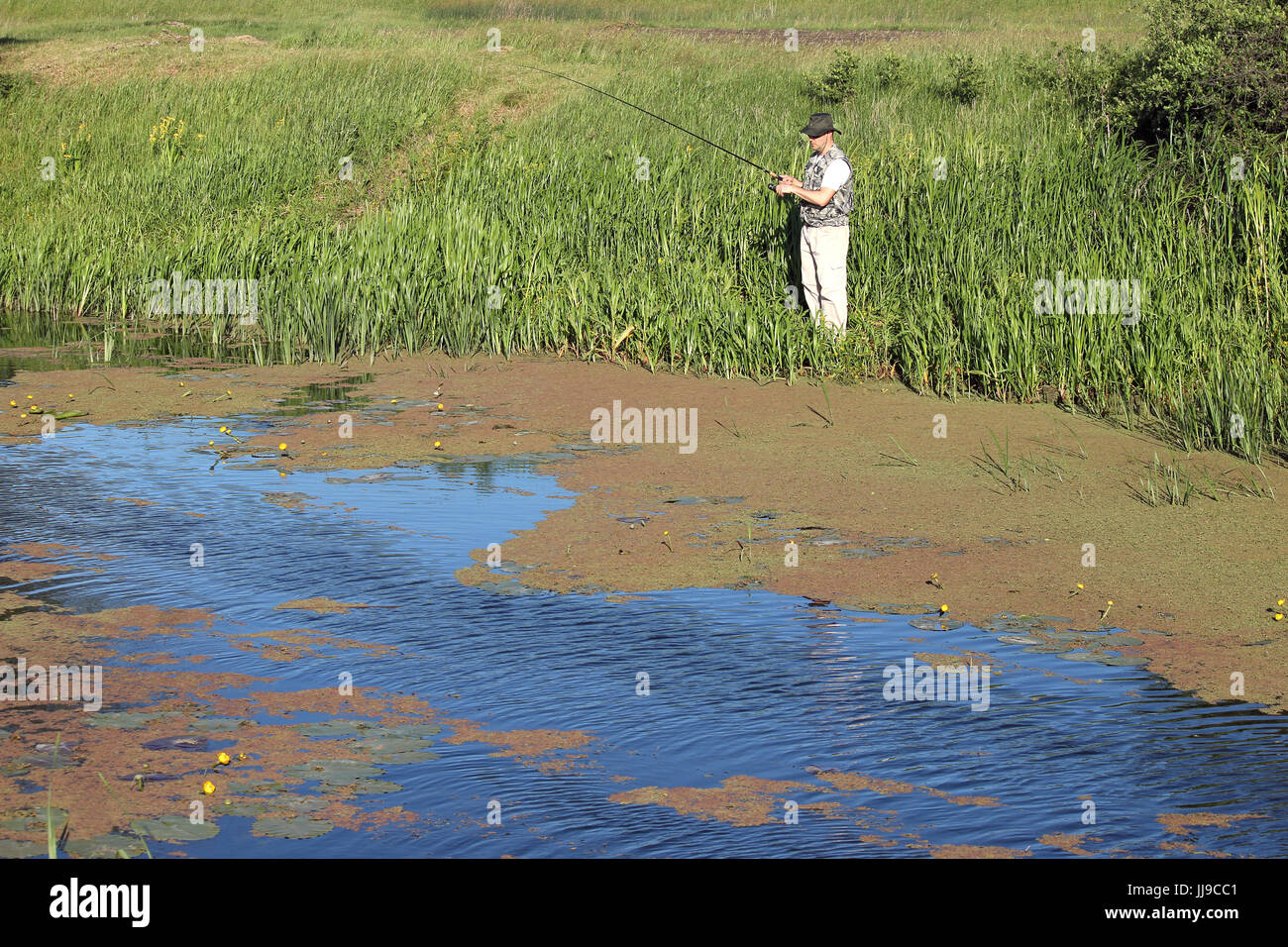 fisherman fishing fish on river Stock Photo - Alamy