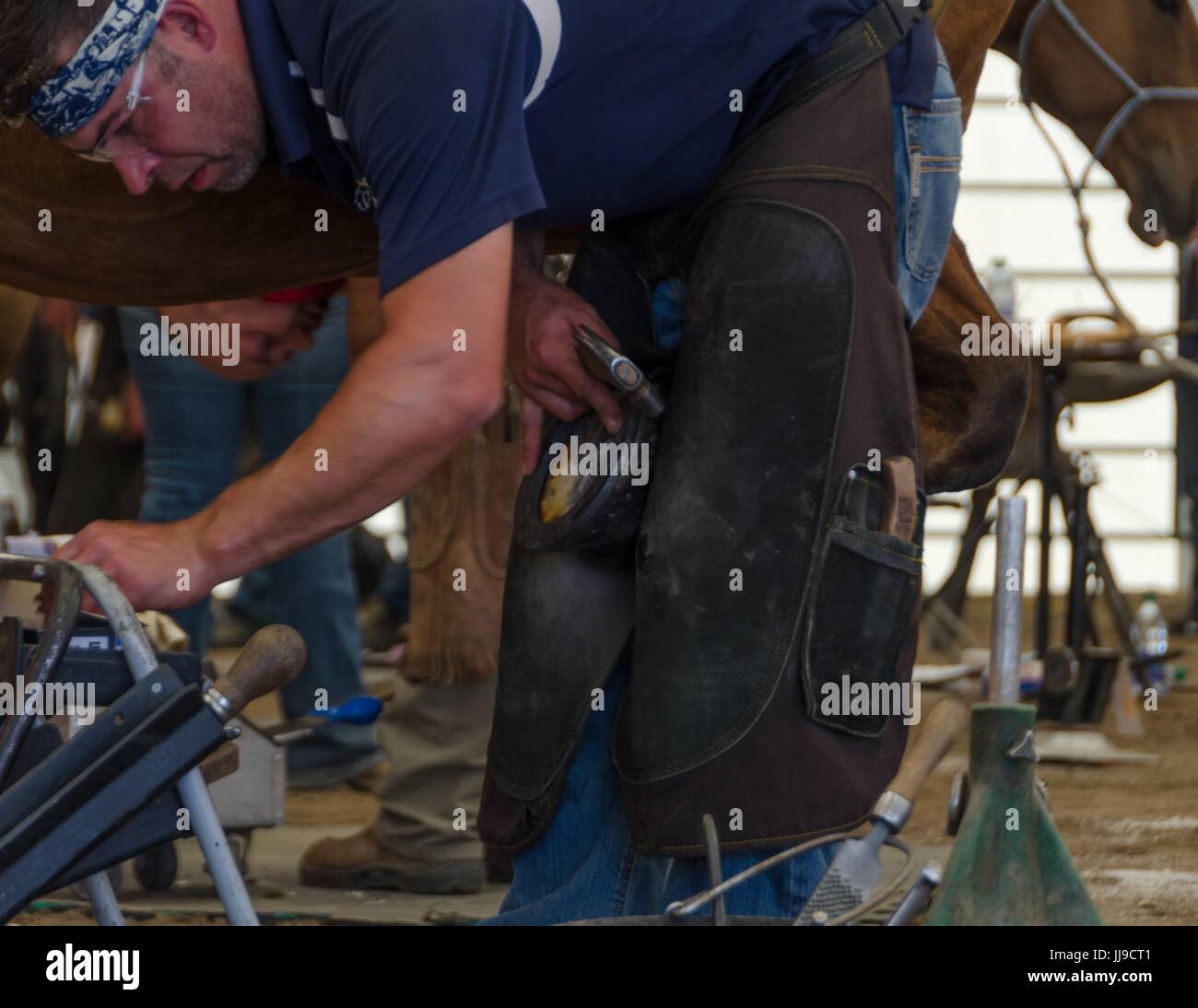 Cowboy horseshoeing a horse hi-res stock photography and images - Alamy