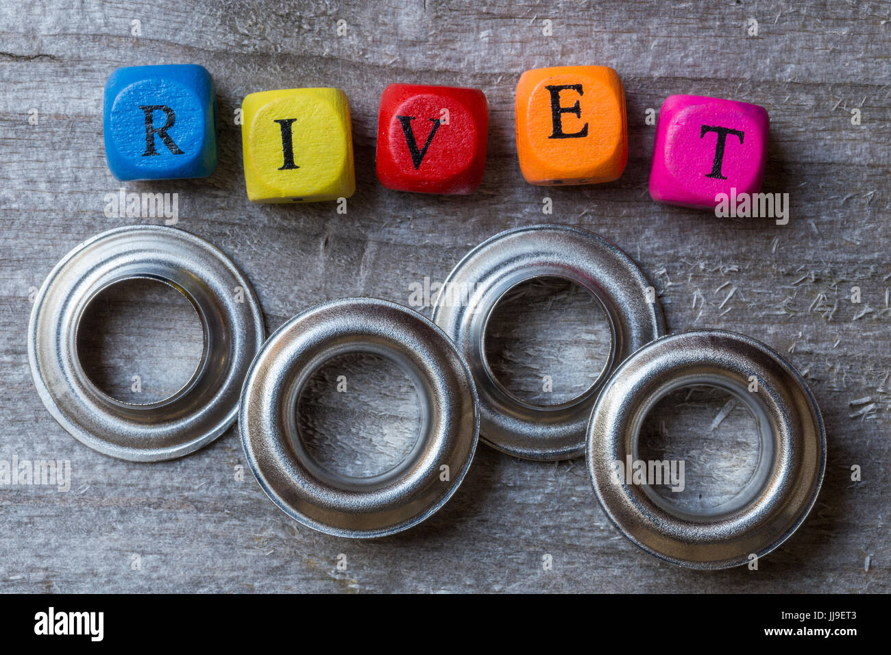 Letter cube and rivets on gray wood visualization Stock Photo - Alamy