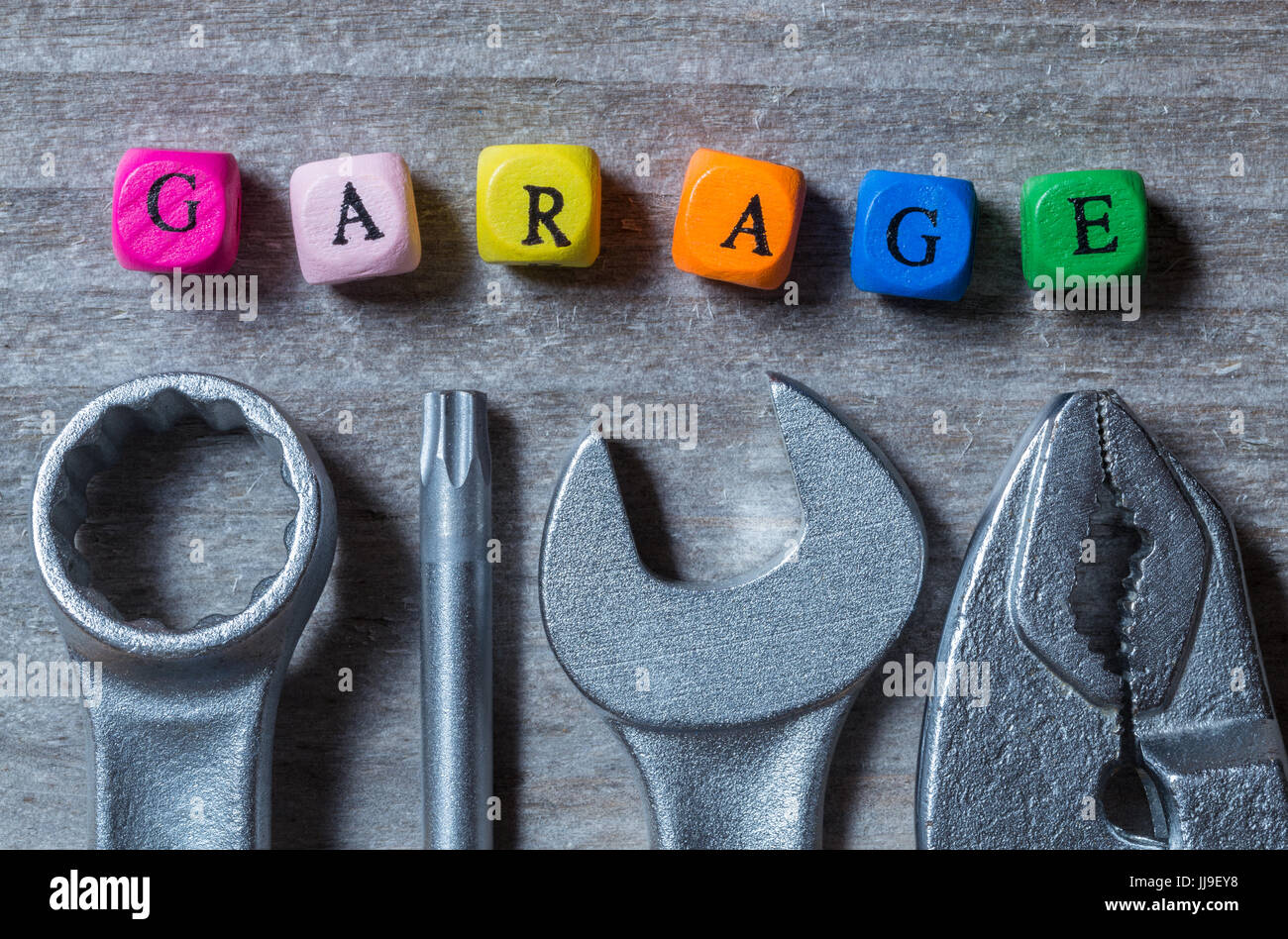Garage letter cube and tool on gray wood visualization Stock Photo - Alamy