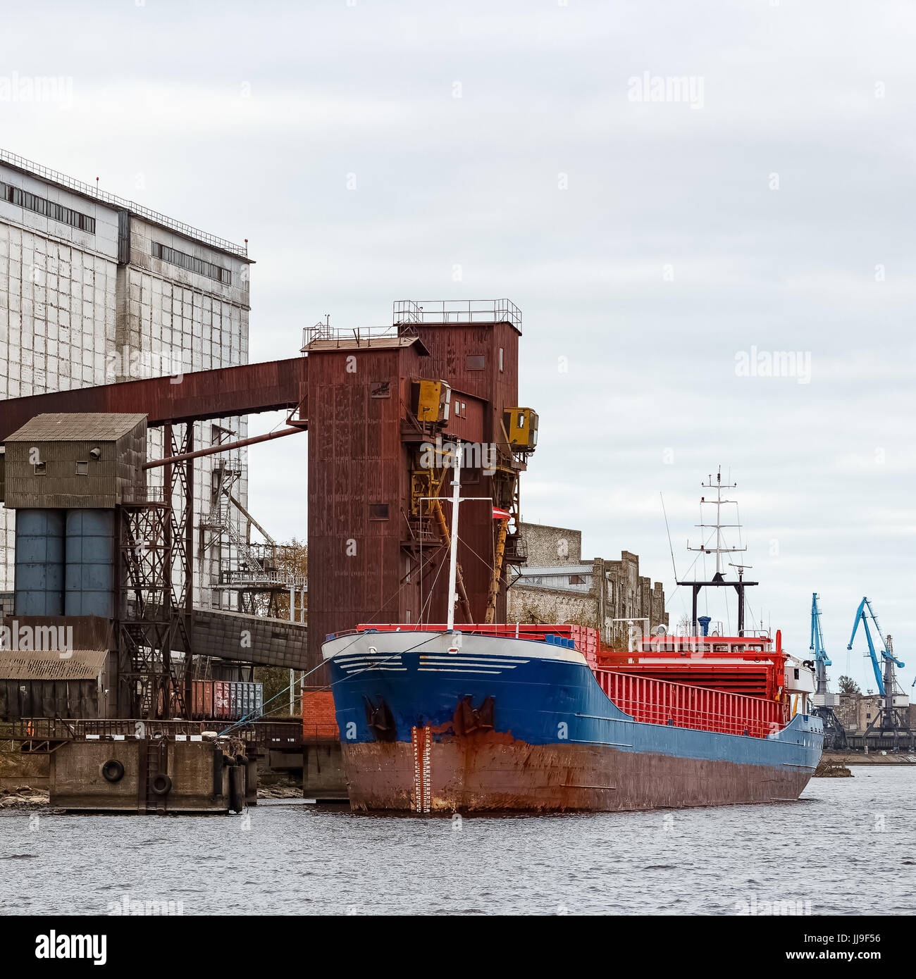 Blue cargo ship loading in the port of Riga, Europe Stock Photo - Alamy