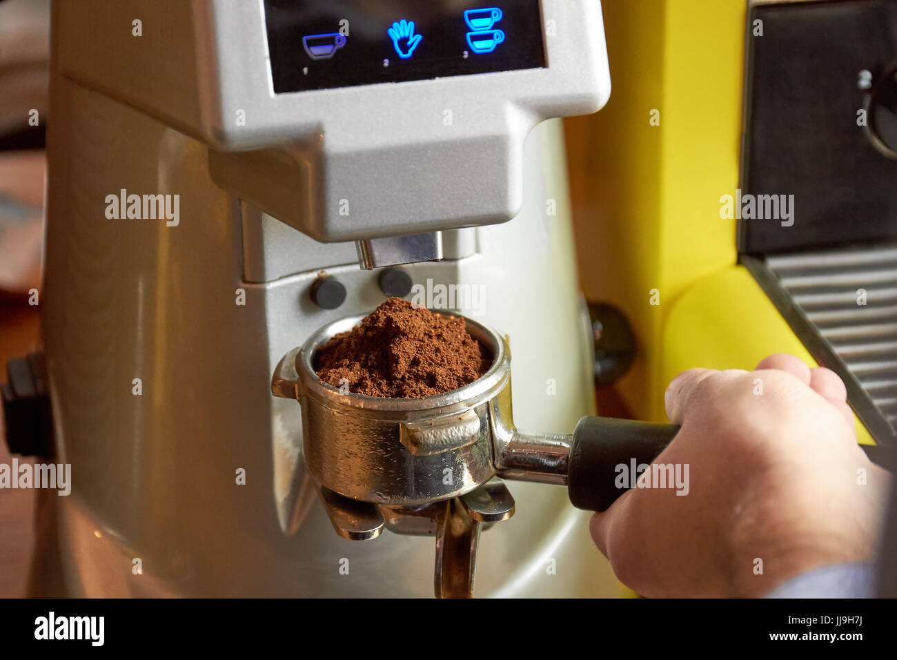 Coffee machine and male hand Stock Photo - Alamy