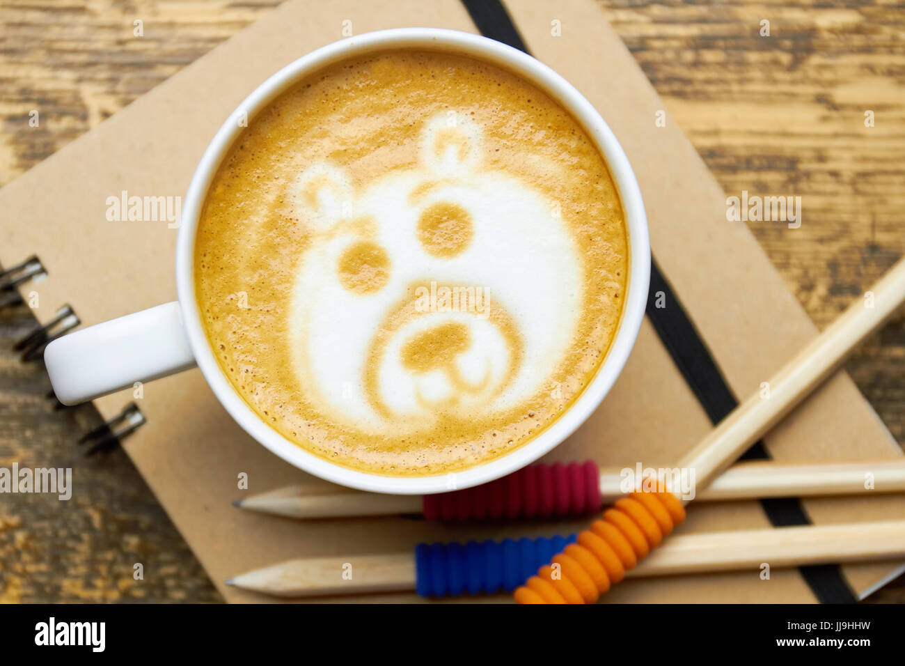 Coffee cup, notebook and pencils Stock Photo - Alamy