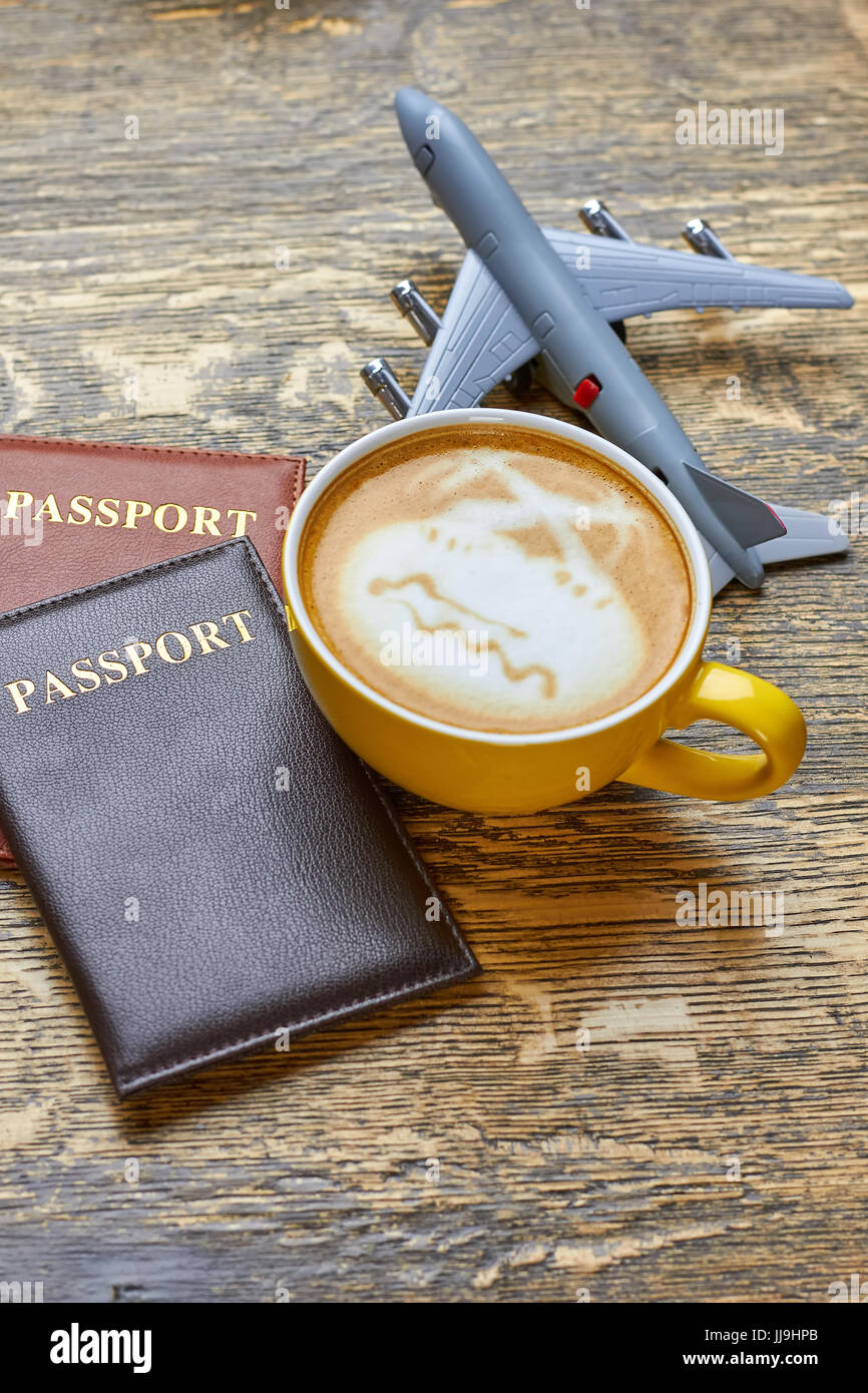 Coffee, passports and toy plane Stock Photo - Alamy