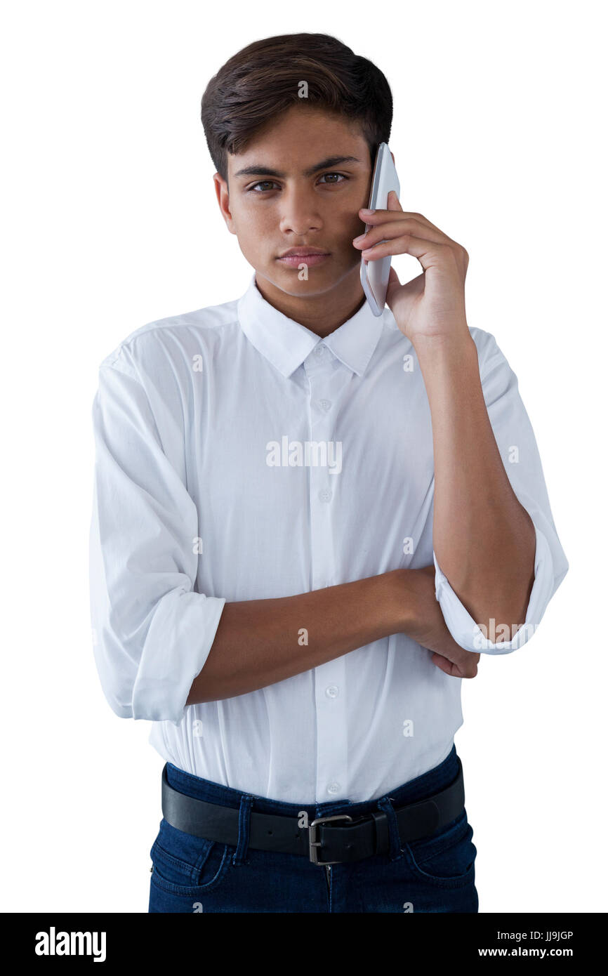 Boy talking on mobilephone against white background Stock Photo - Alamy