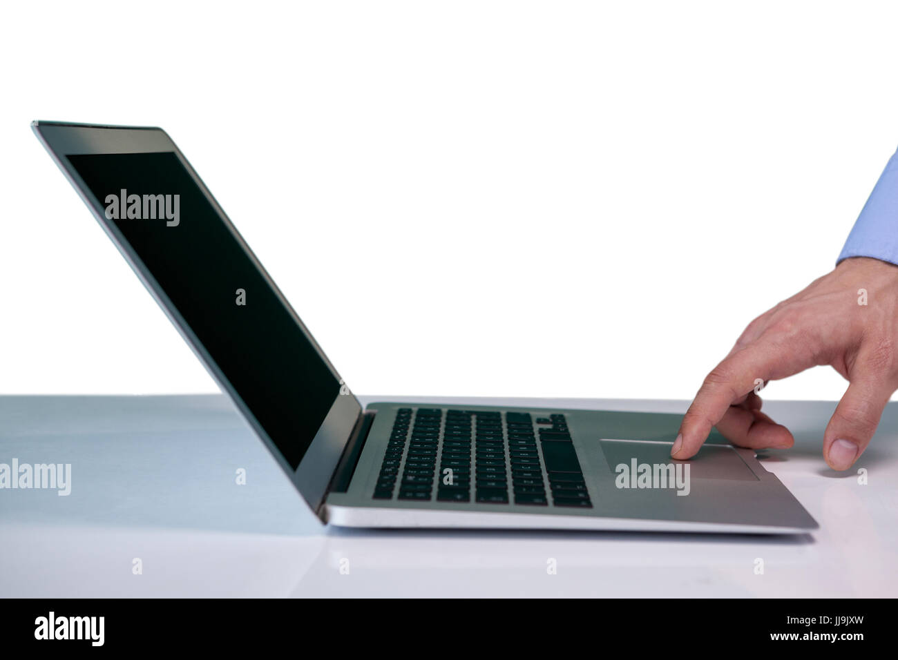 Cropped hand on businessman touching touch pad on laptop against white ...