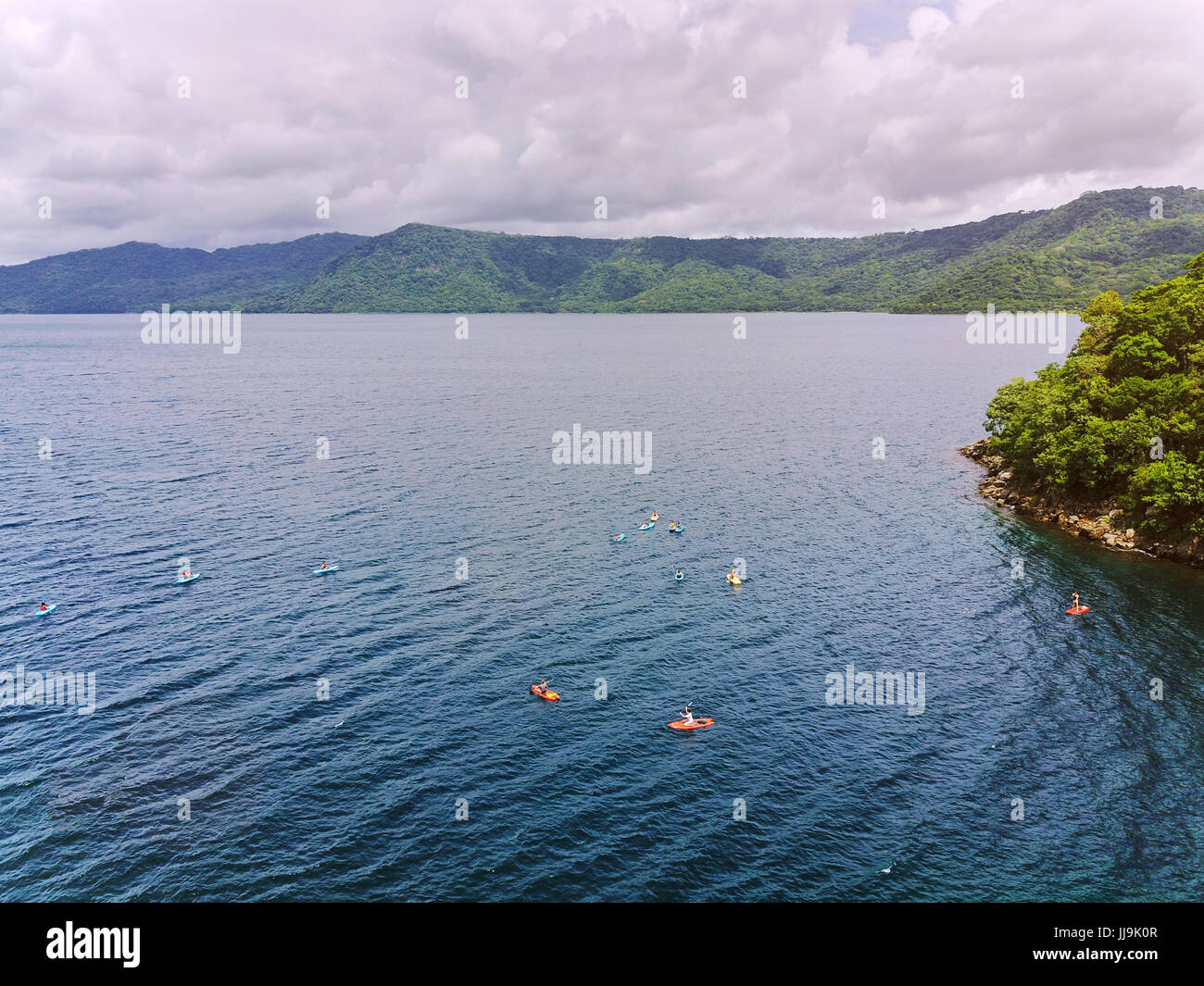 Group of people doing kayaking aerial drone view in blue lagoon Stock ...