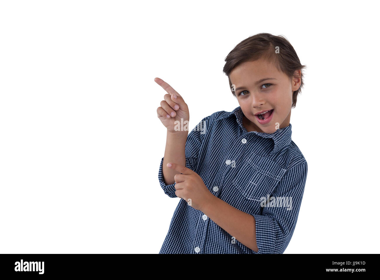 Portrait of cute boy pointing finger against white background Stock ...