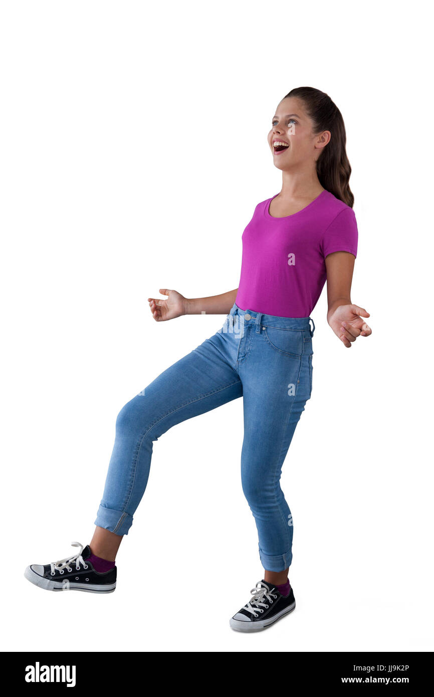Smiling girl dancing against white background Stock Photo - Alamy