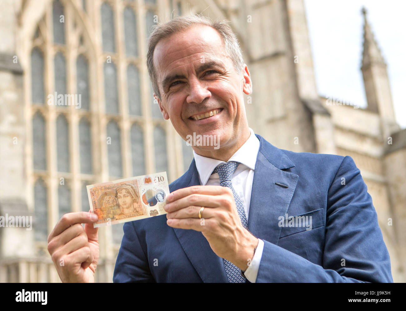 The Governor of the Bank of England, Mark Carney, holds the new Â£10 ...