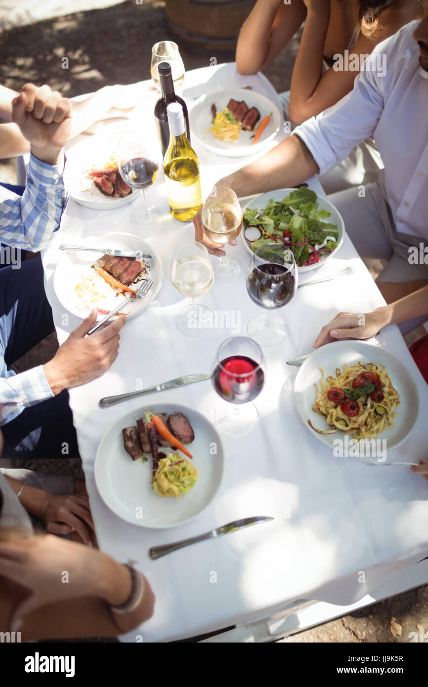 Mid-section of group of friends having lunch in a restaurant Stock ...