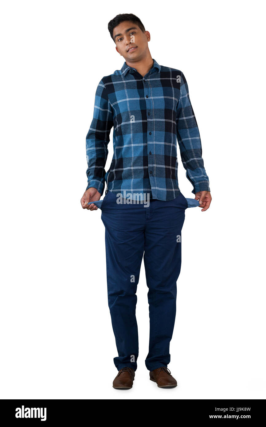 Full length of young man showing empty pockets while standing against ...