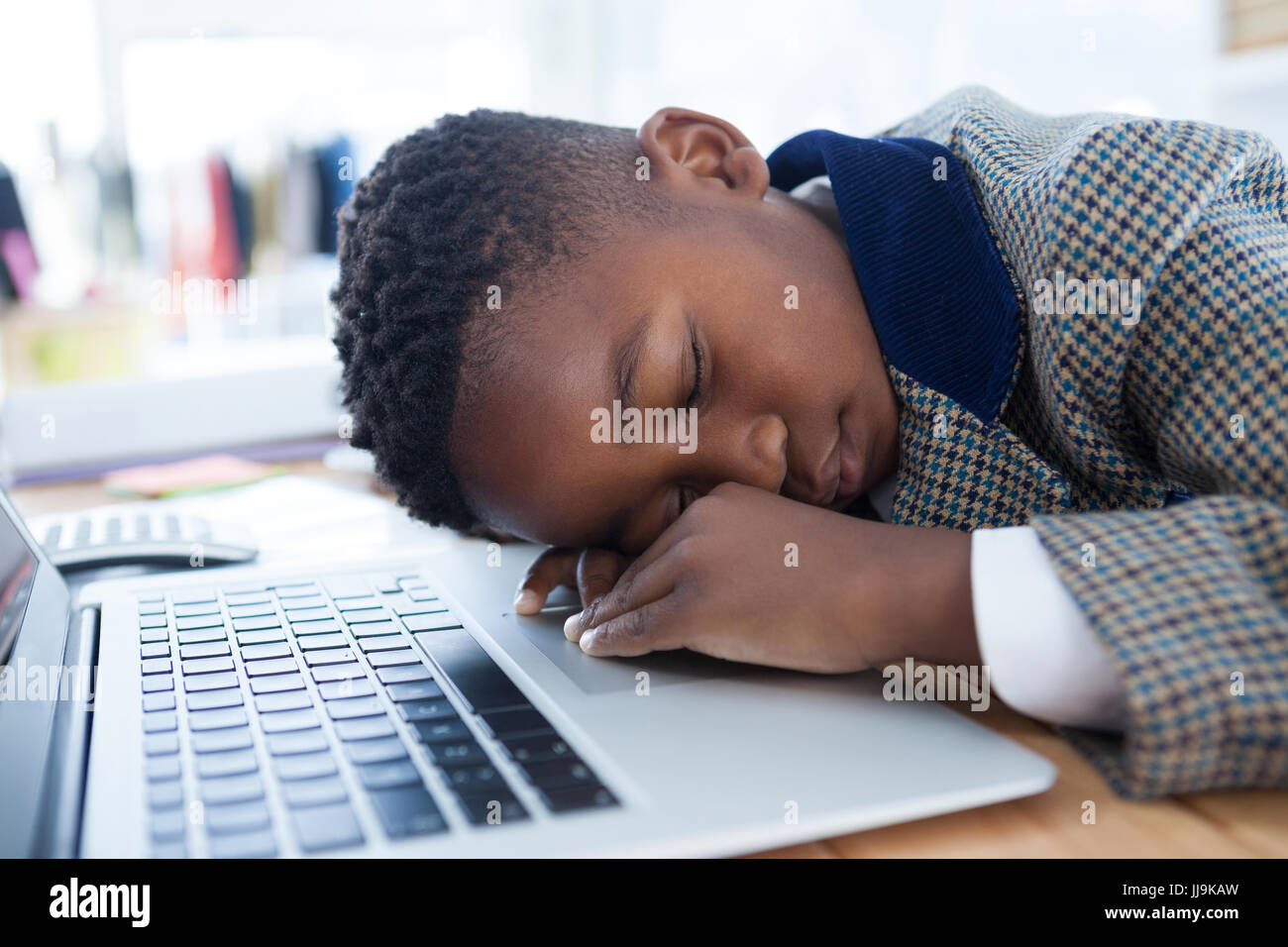Businessman taking a nap on laptop at desk in office Stock Photo - Alamy