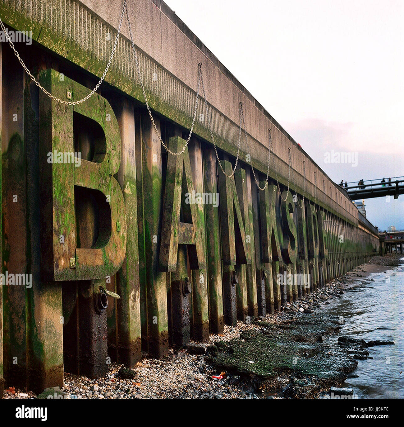 Bankside lettering on wooden side walls of the river Thames seen at low ...