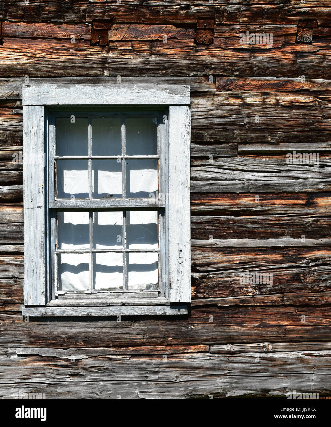 Detail of a window in a log cabin Stock Photo - Alamy