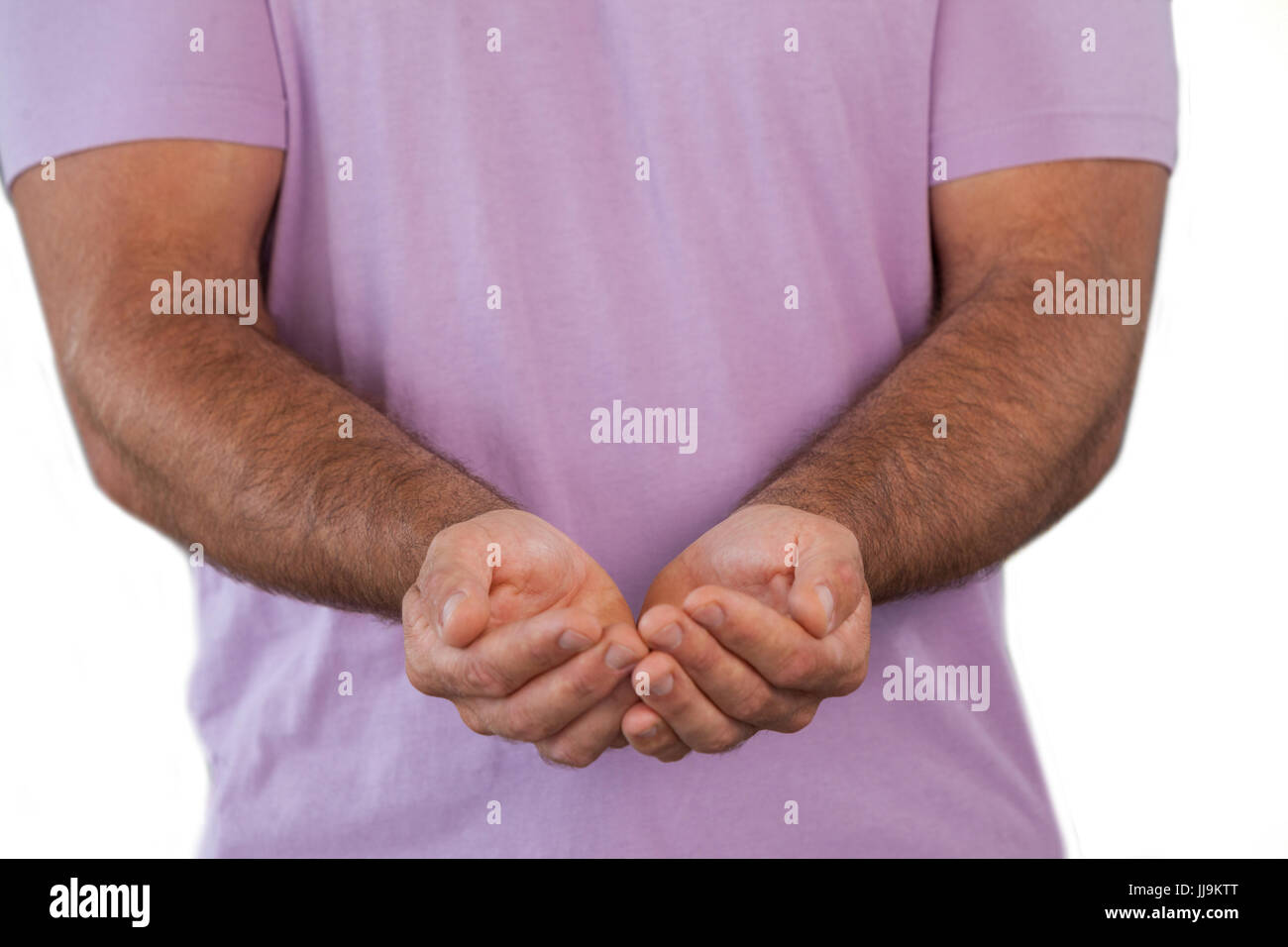 Mid section of man with hands cupped standing against white background ...