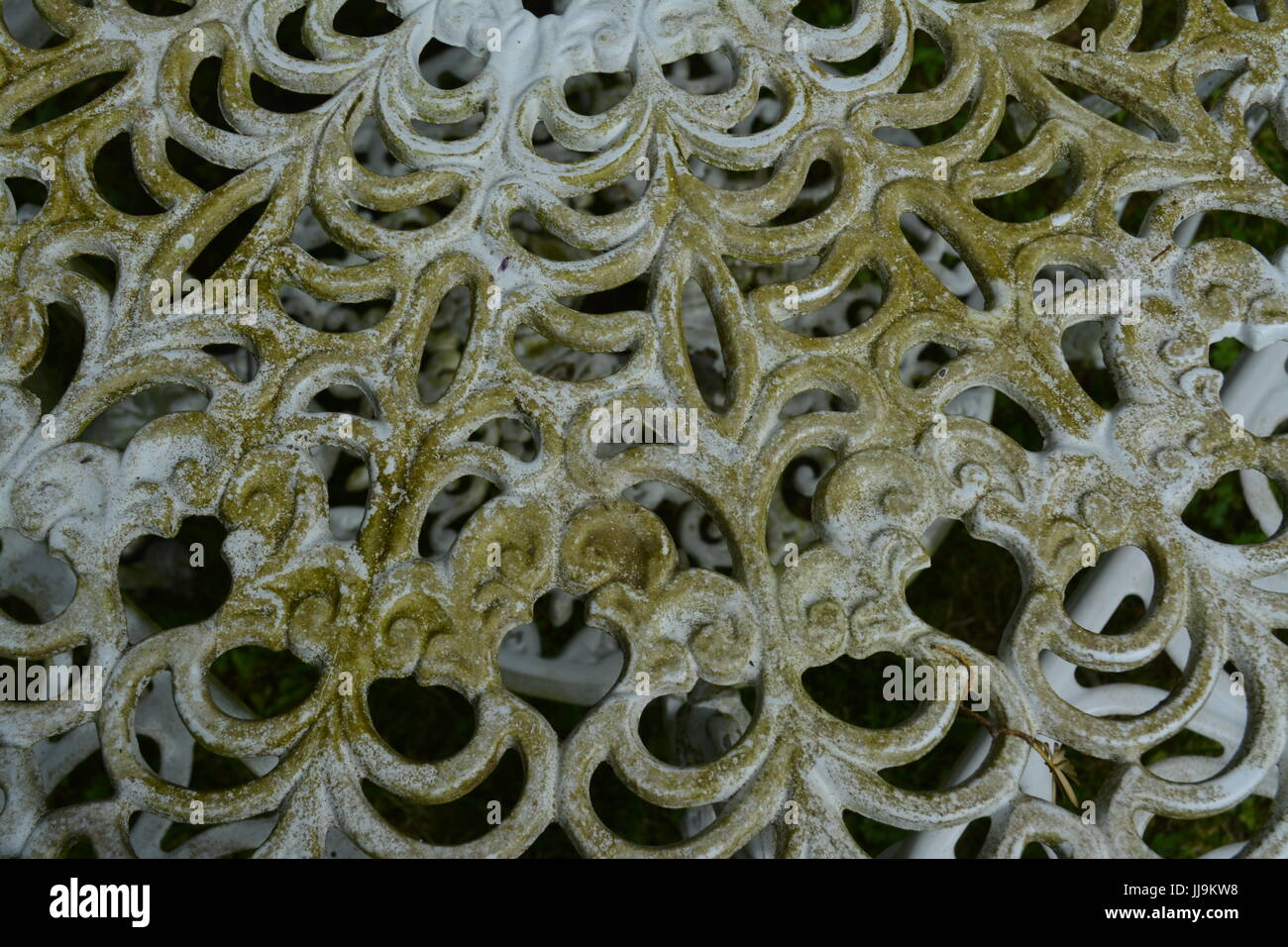 close up of white painted aluminium garden furniture re scrolling ...