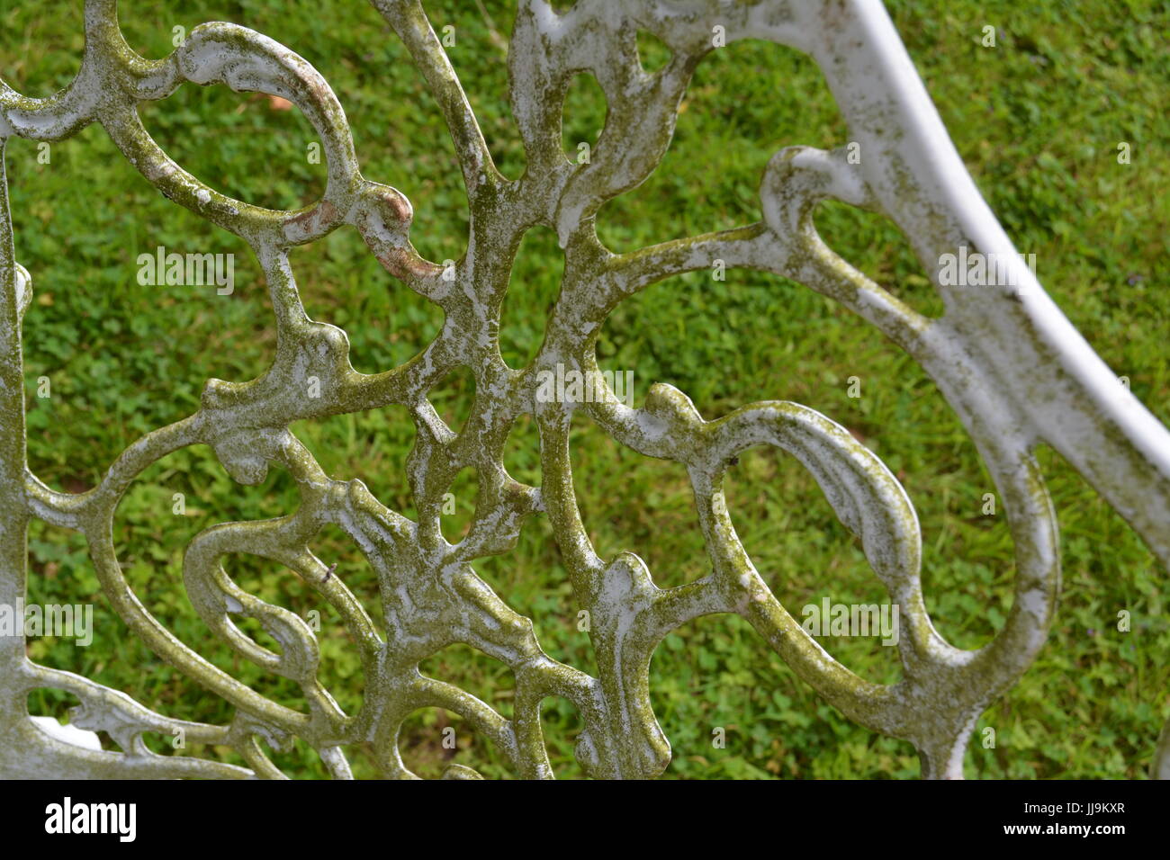 close up of white painted aluminium garden furniture re scrolling ...