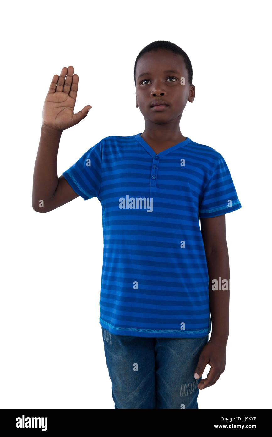 Cute boy raising his hand against white background Stock Photo - Alamy