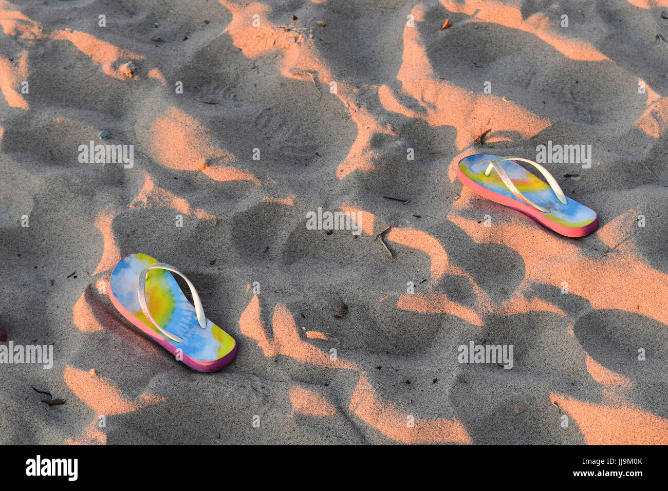 Flip flops in the sand Stock Photo - Alamy