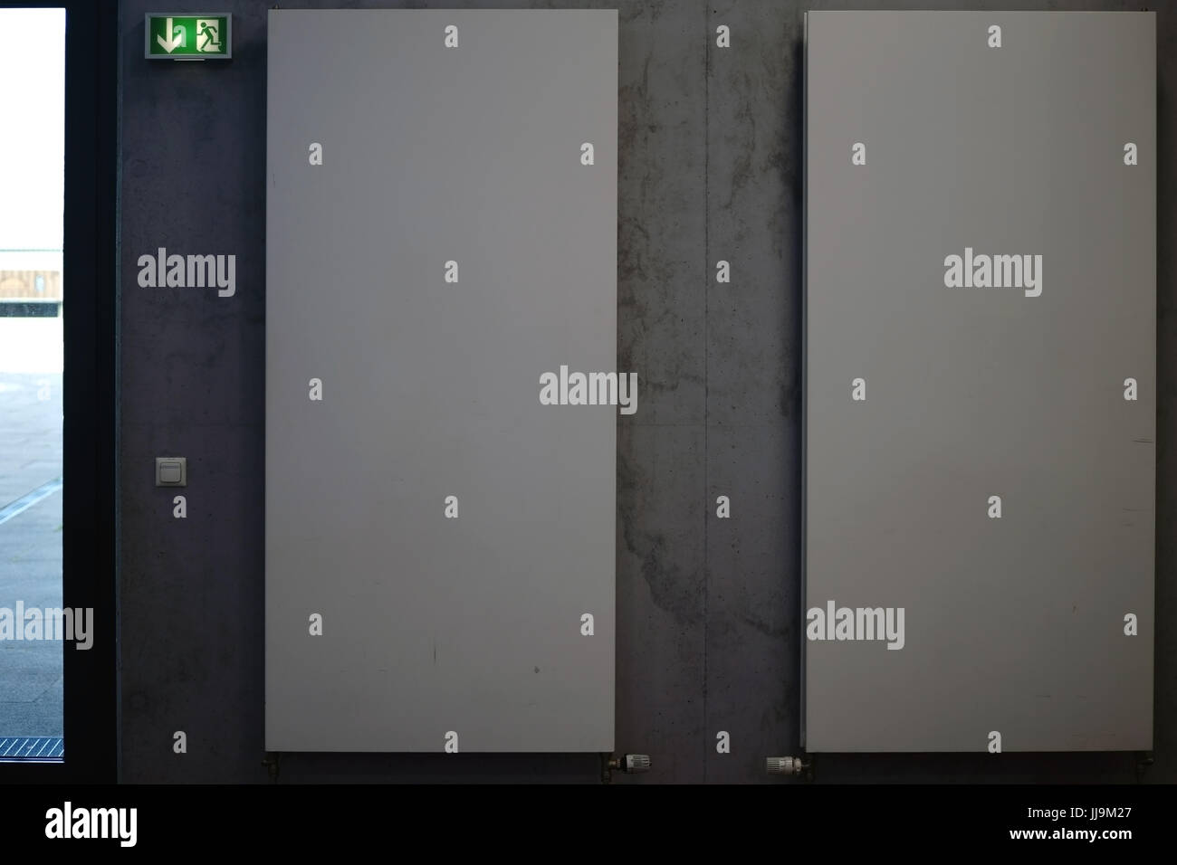 Two high wall radiators hanging on a striking concrete wall Stock Photo ...