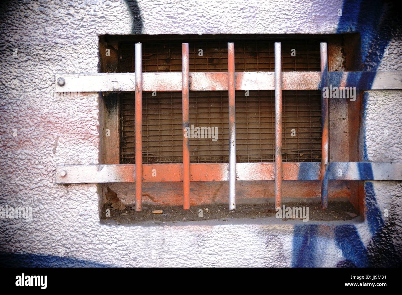 The closeup of a colorful painted basement with rusted iron bars Stock ...