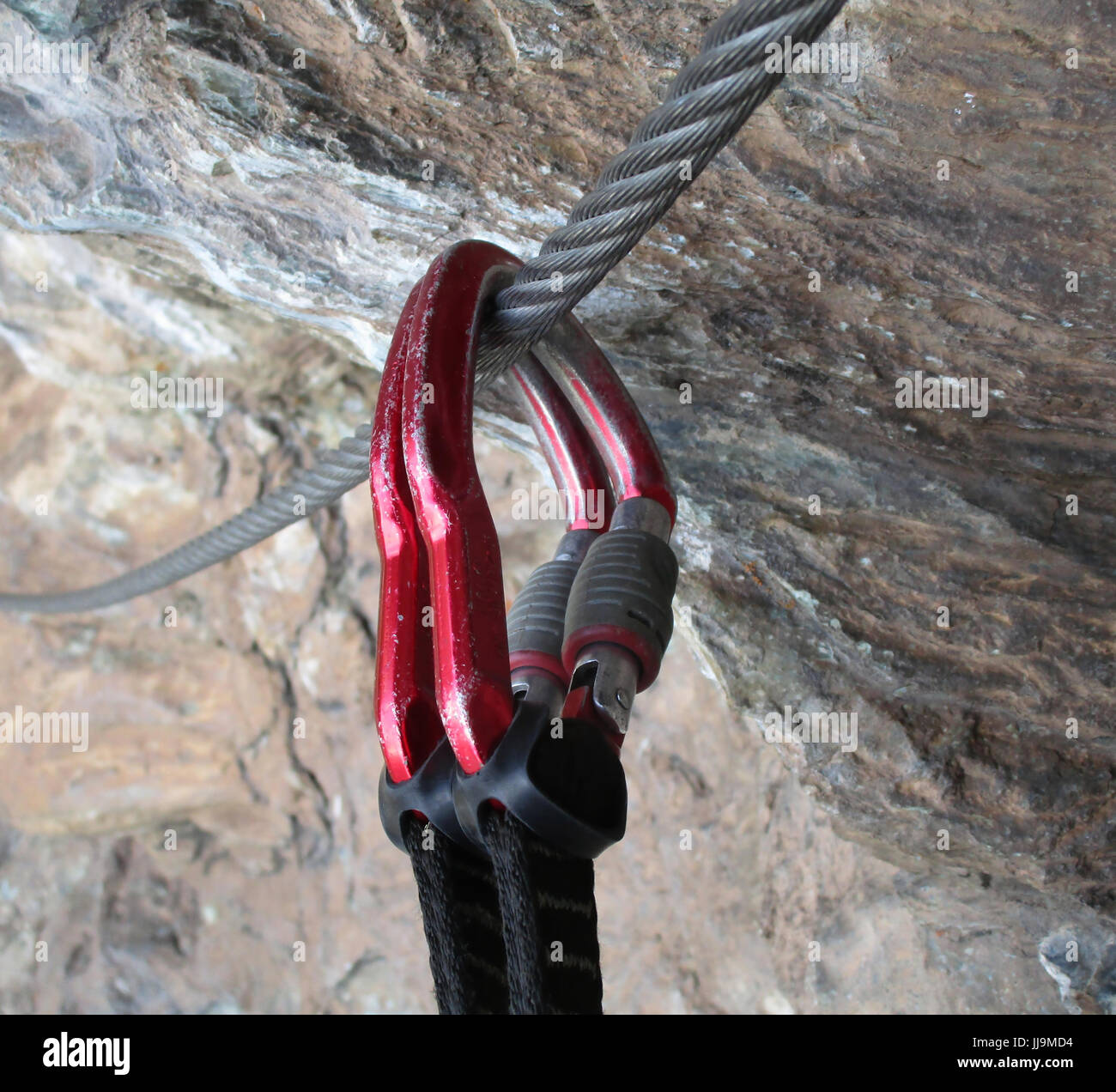 Carabiners hooked with wire rope Stock Photo - Alamy