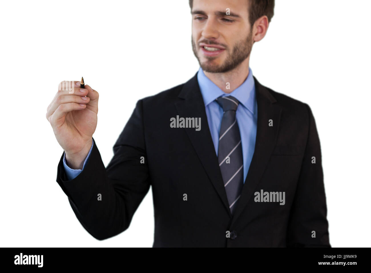 Smiling businessman writing on invisible interface against white ...