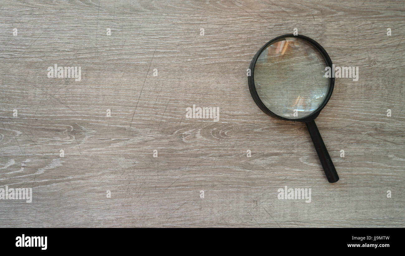 magnifying glass on the grey laminate background Stock Photo - Alamy
