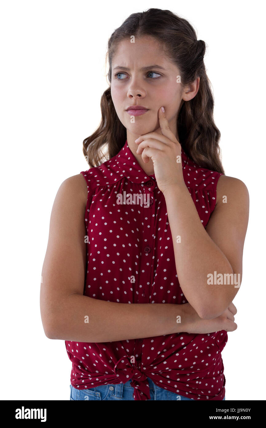 Confused teenage girl standing against white background Stock Photo - Alamy
