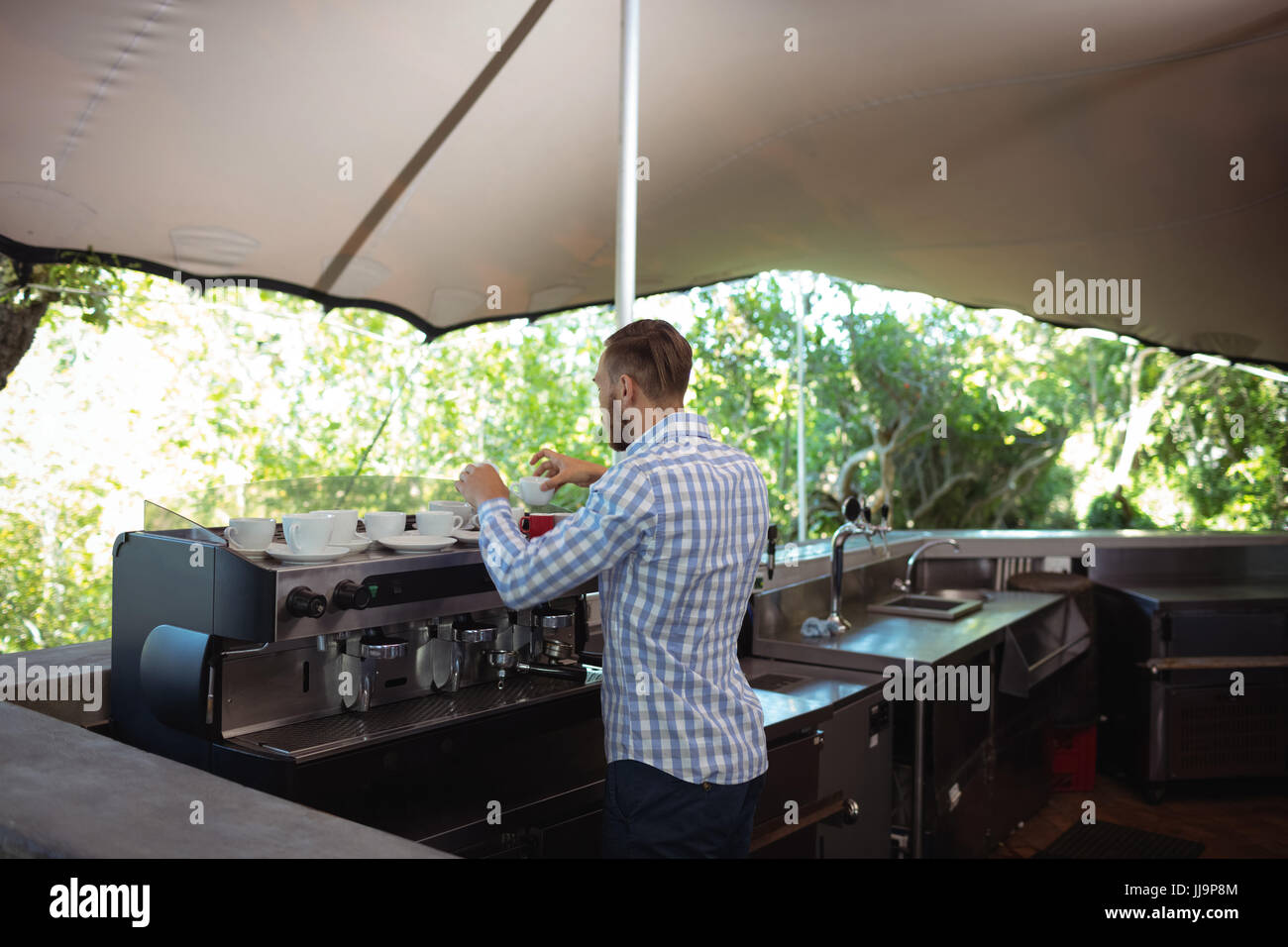 Rear view of waiter preparing coffee at outdoor cafÃƒÂ© Stock Photo - Alamy