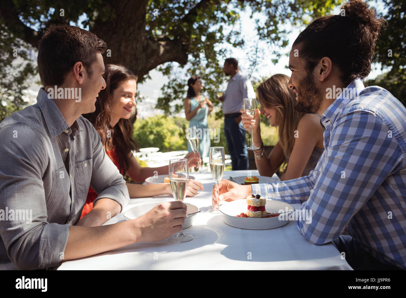 Group of friends having lunch in a restaurant Stock Photo - Alamy