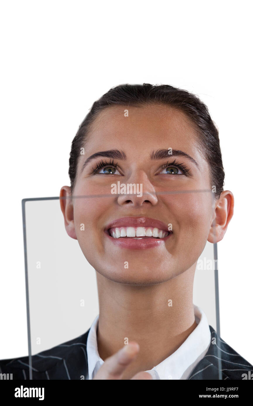 Close up of smiling businesswoman looking up while using glass ...