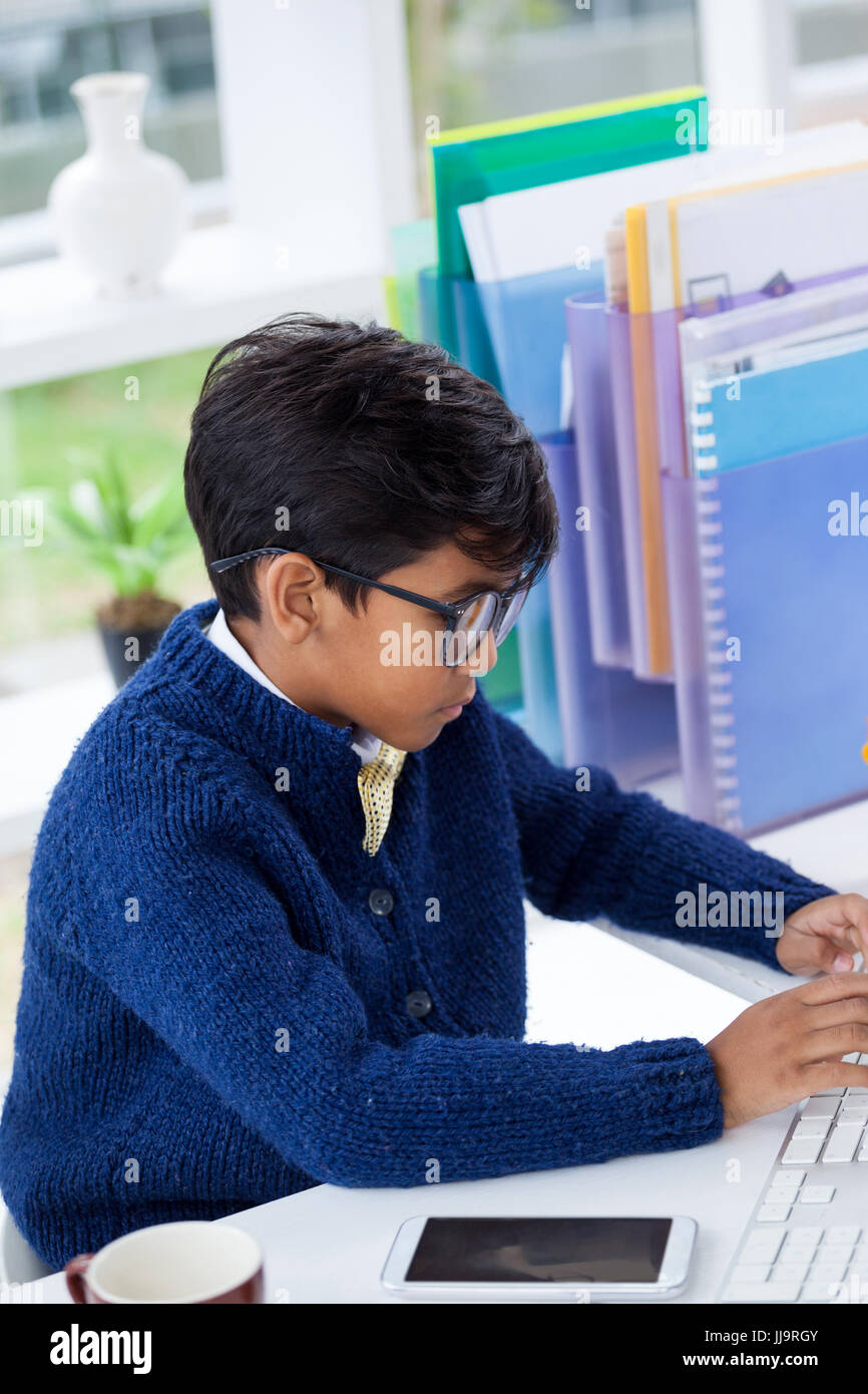 Side view of businessman using desktop computer while sitting in office ...