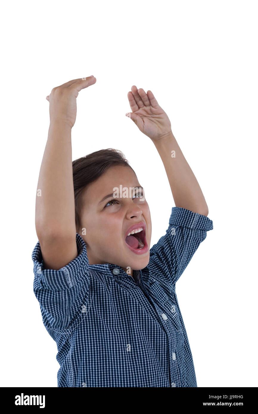 Cute boy shouting against white background Stock Photo - Alamy