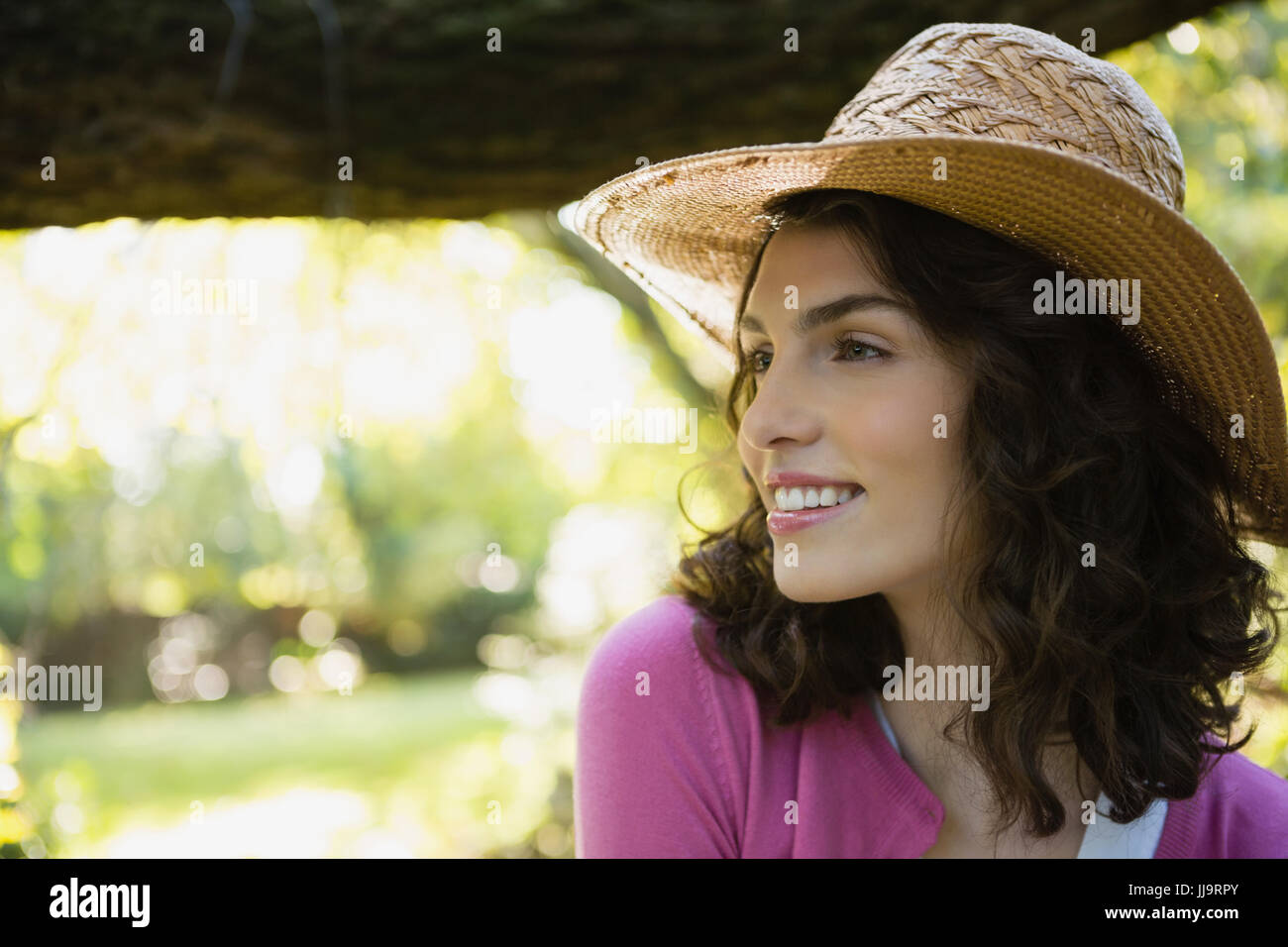 Close-up of smiling beautiful woman in garden Stock Photo - Alamy