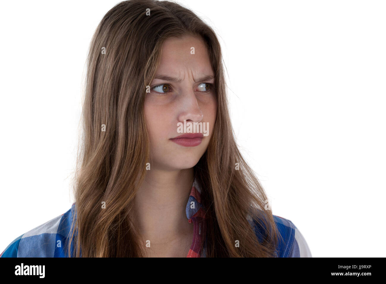 Confused teenage girl standing against white background Stock Photo - Alamy