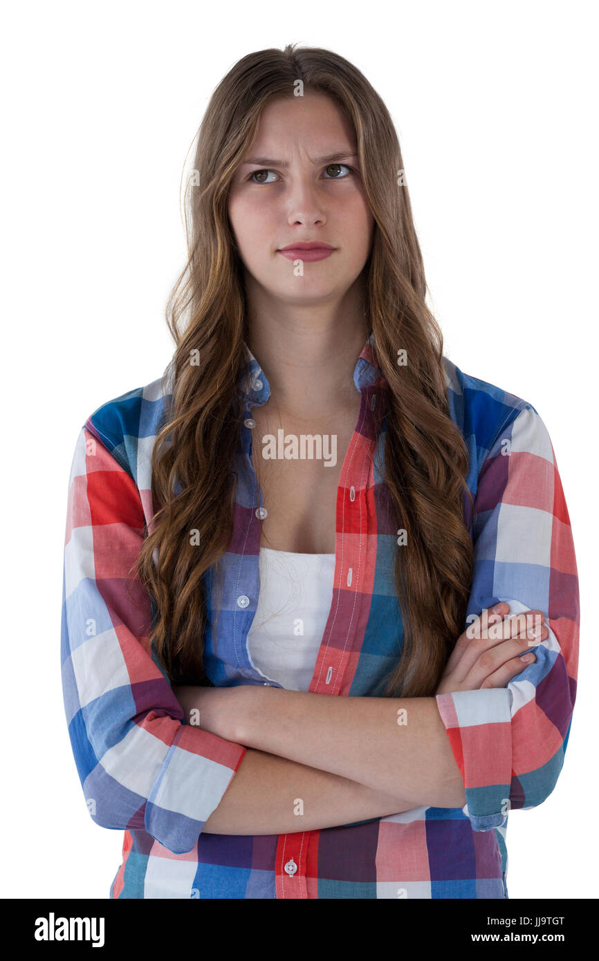 Confused teenage girl standing against white background Stock Photo - Alamy