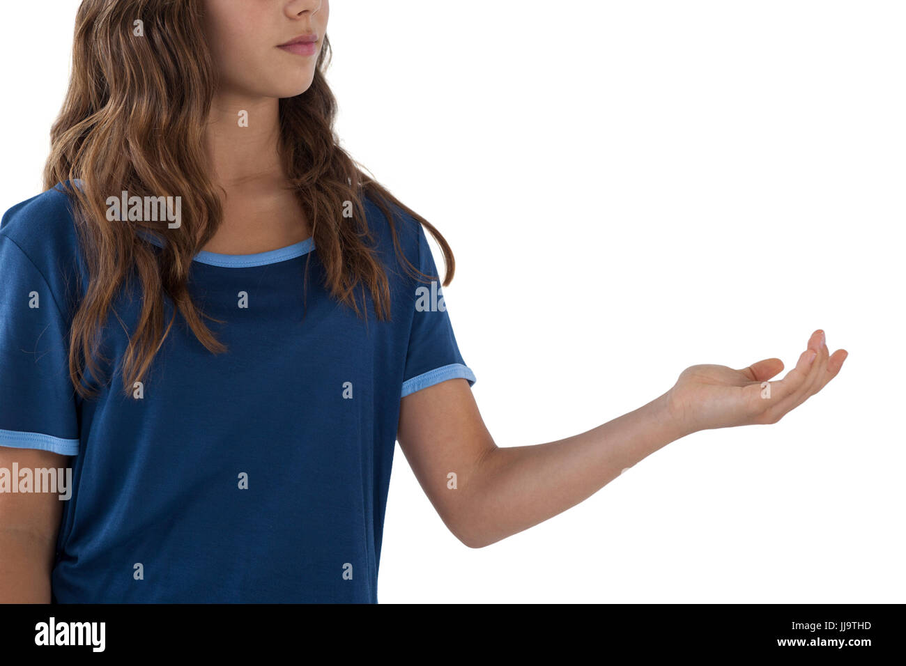 Smiling girl with hand cupped against white background Stock Photo - Alamy