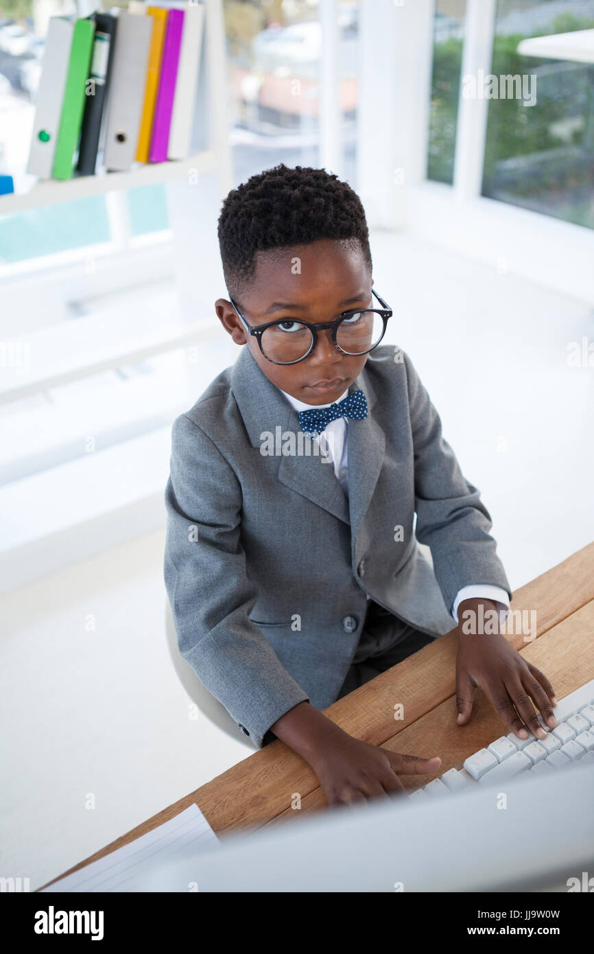 High angle portrait of businessman using computer at desk in office ...