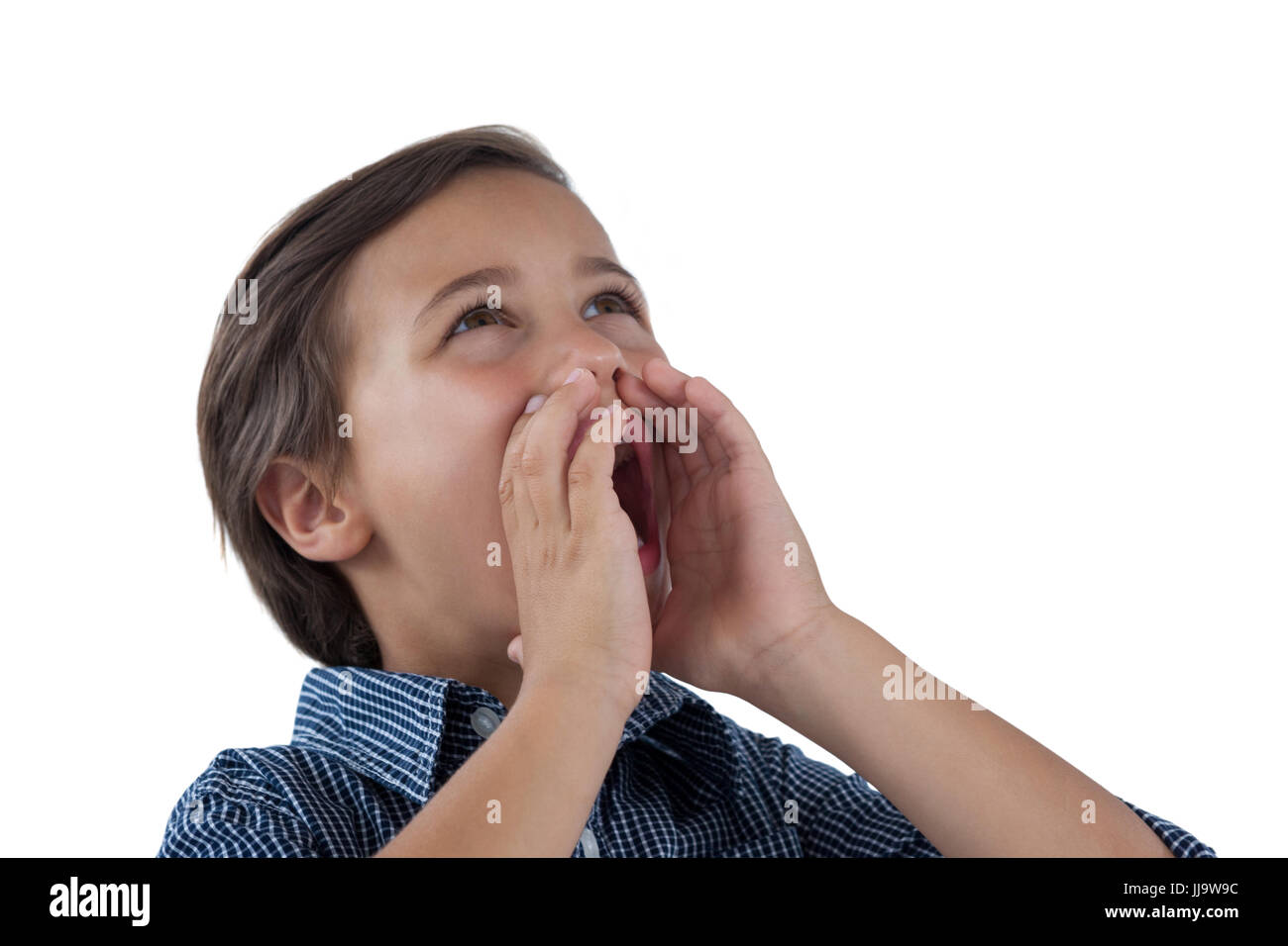 Cute boy shouting against white background Stock Photo - Alamy