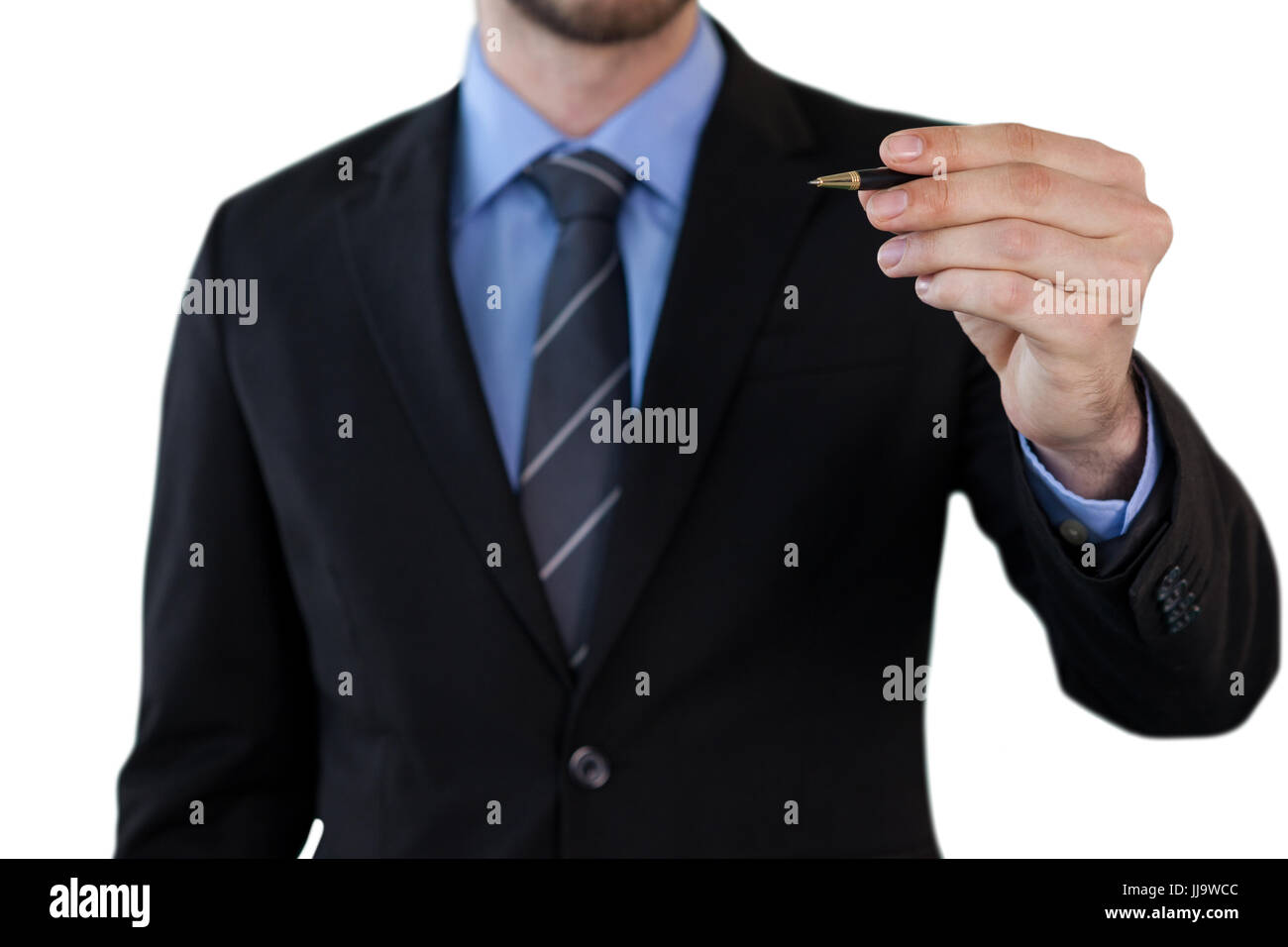 Mid section of businessman writing on invisible interface while ...