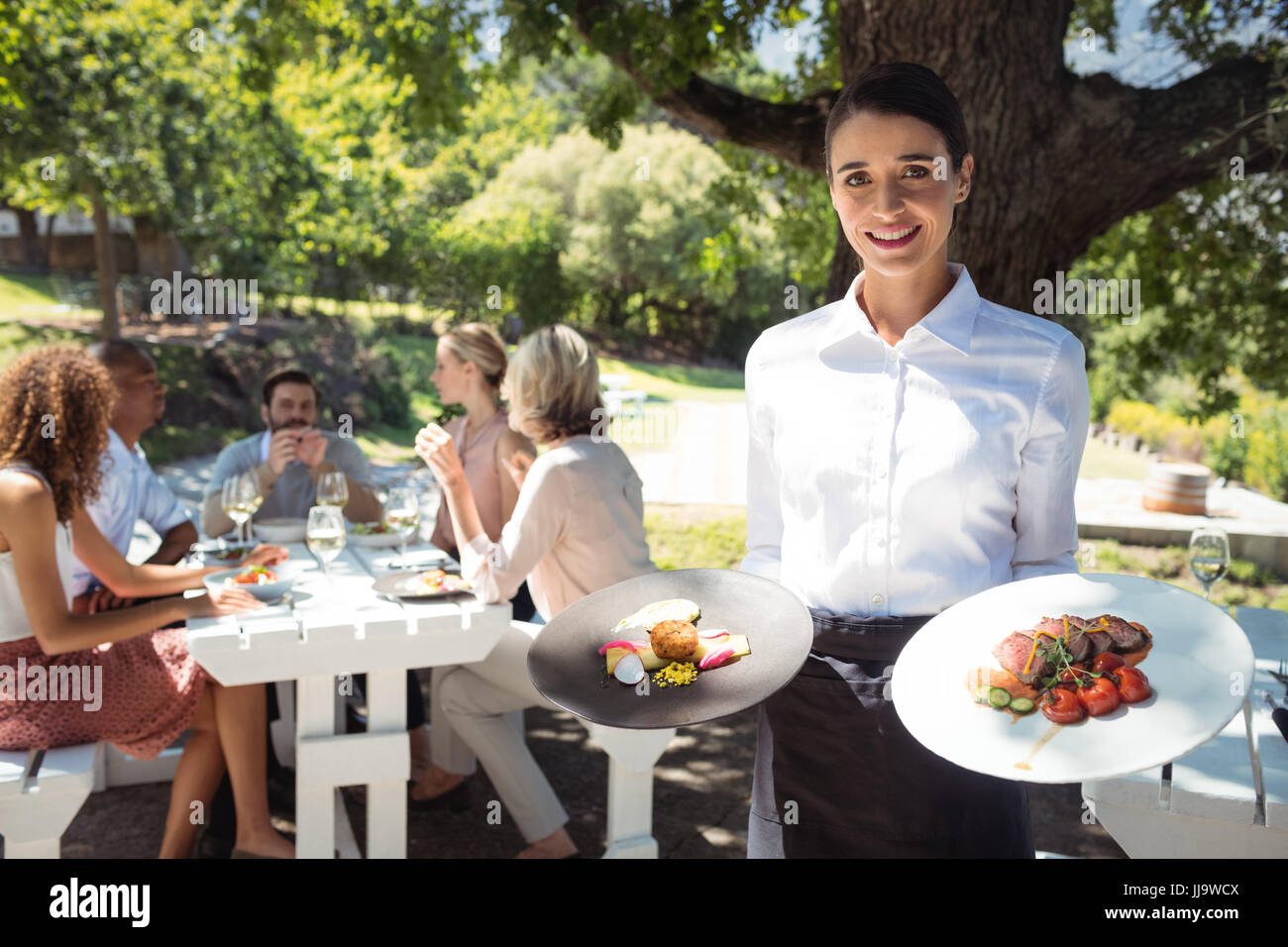 Restaurant waiter carrying plates food hi-res stock photography and ...