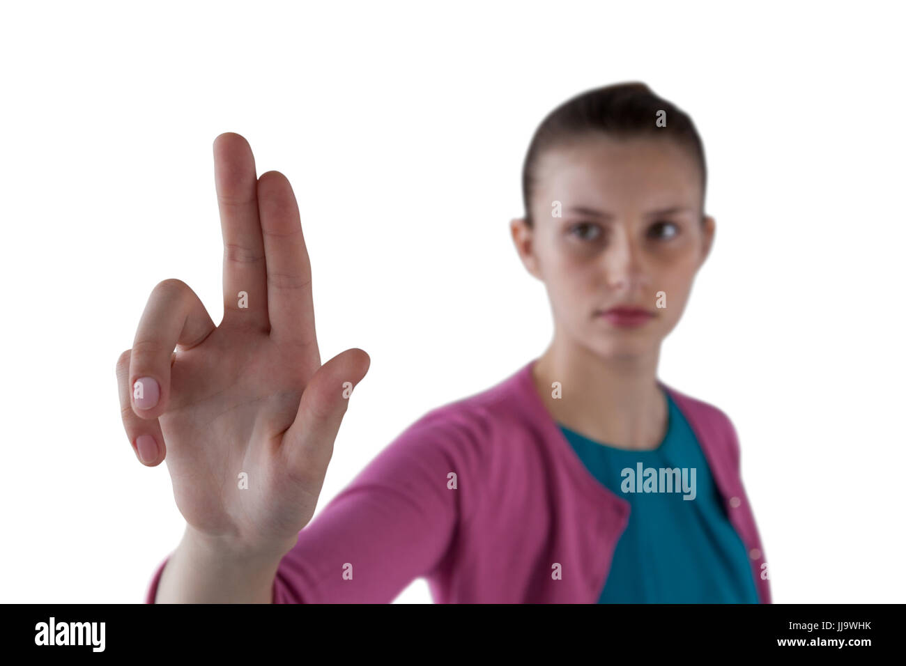 Teenage girl pressing an invisible virtual screen against white ...