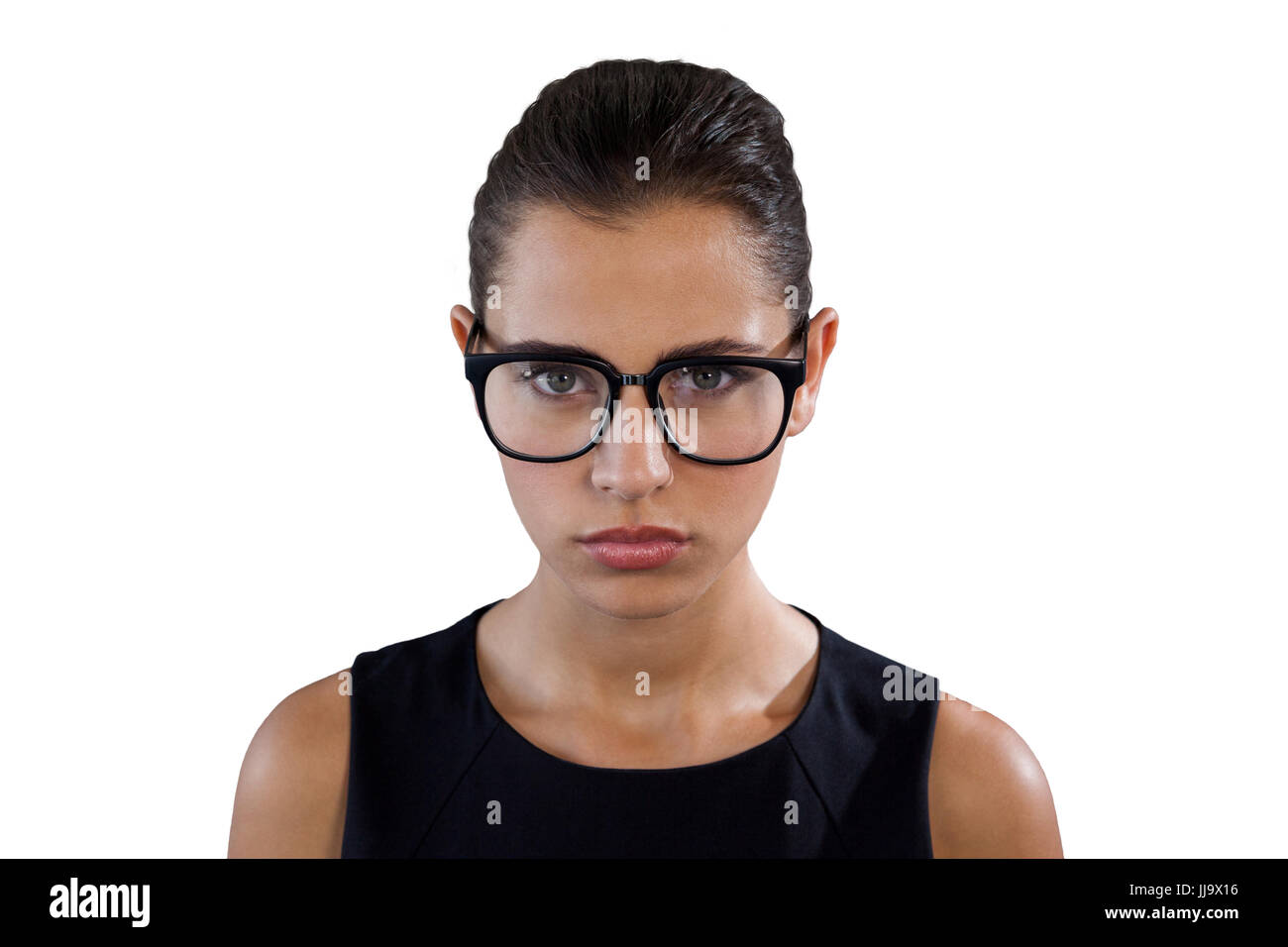 Portrait of serious young businesswoman wearing eyeglasses against ...
