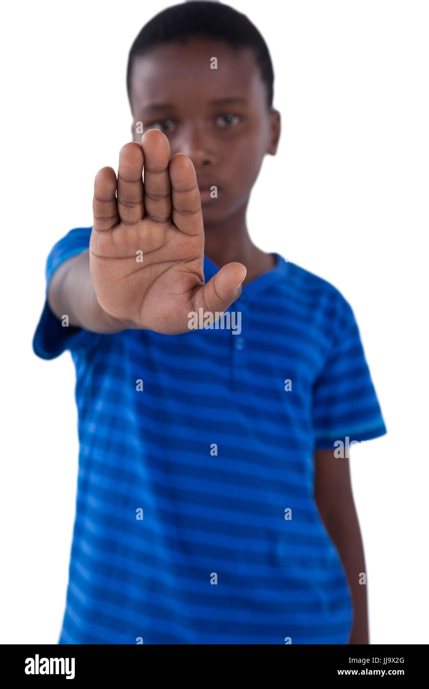 Portrait of cute boy showing his hand while ignoring Stock Photo - Alamy