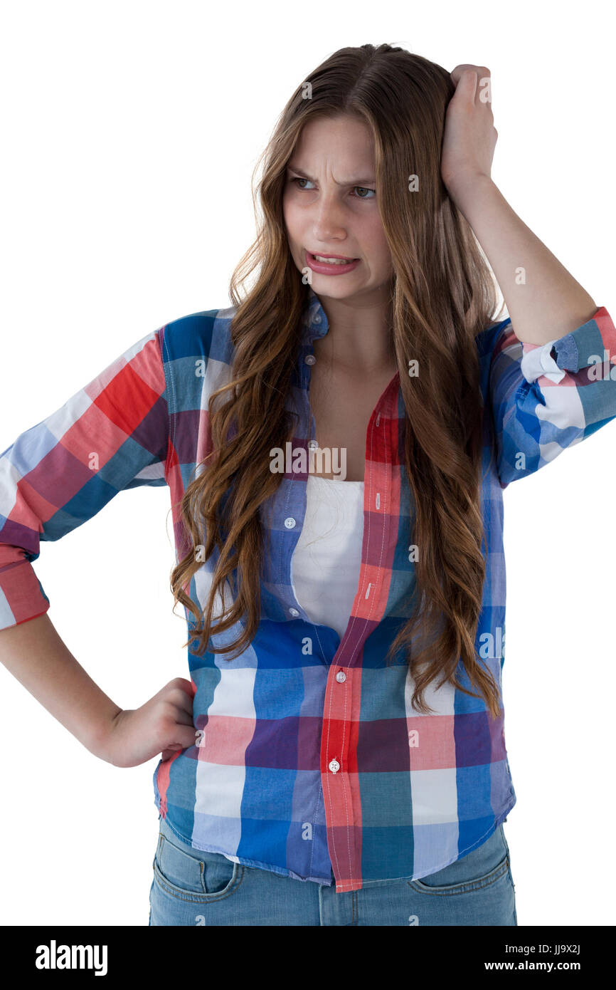 Confused teenage girl standing against white background Stock Photo - Alamy