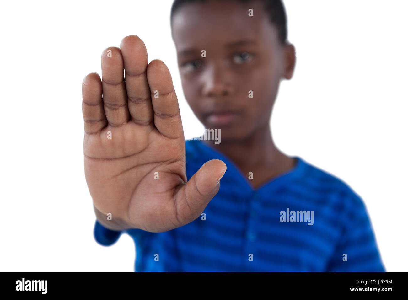 Portrait of cute boy showing his hand while ignoring Stock Photo - Alamy