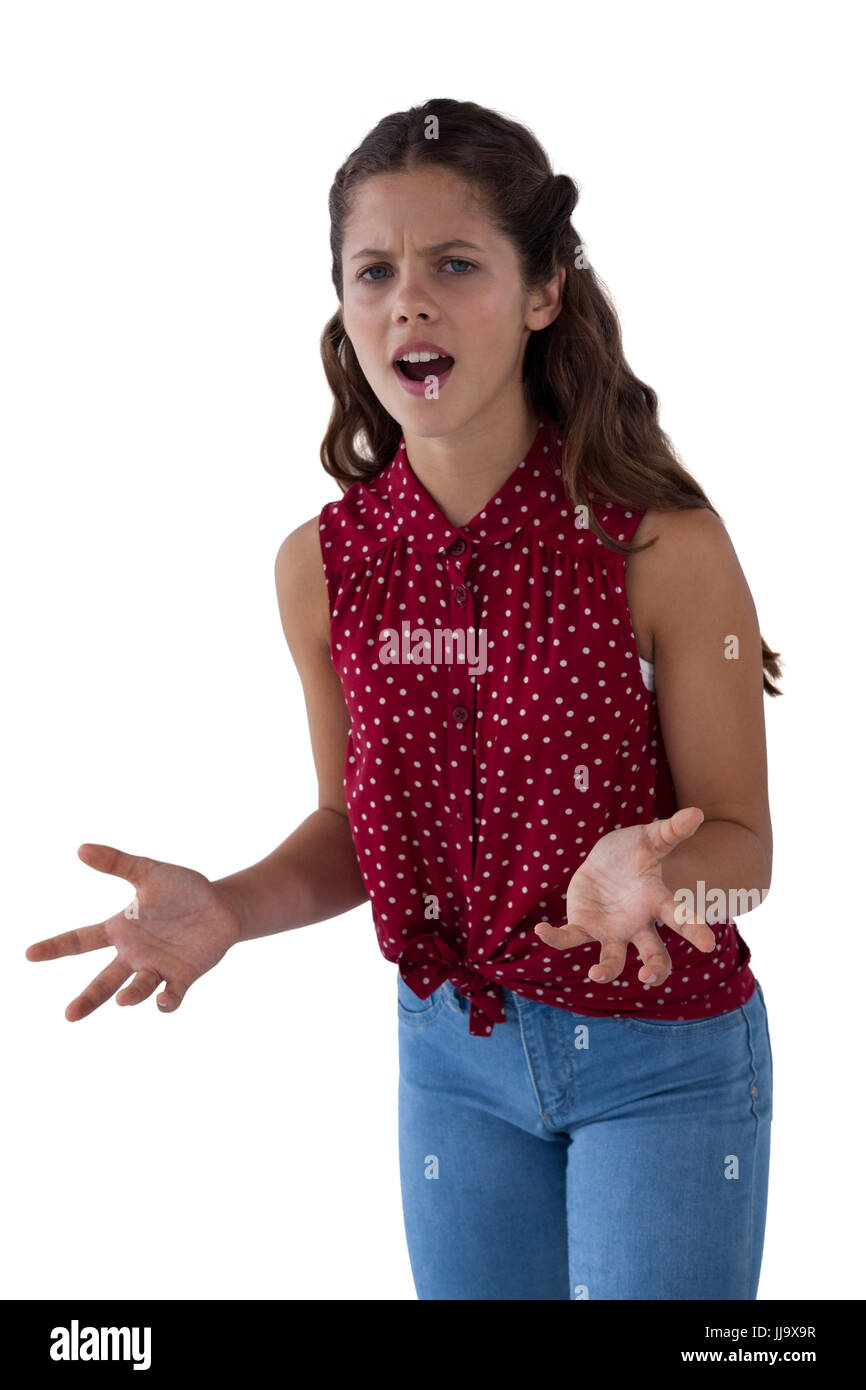 Confused teenage girl standing against white background Stock Photo - Alamy